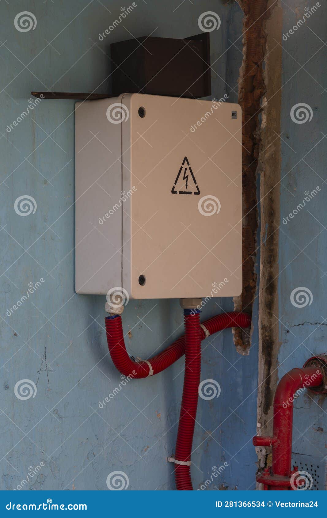 A Square White Box with an Electrical Panel on the Wall of a Building ...