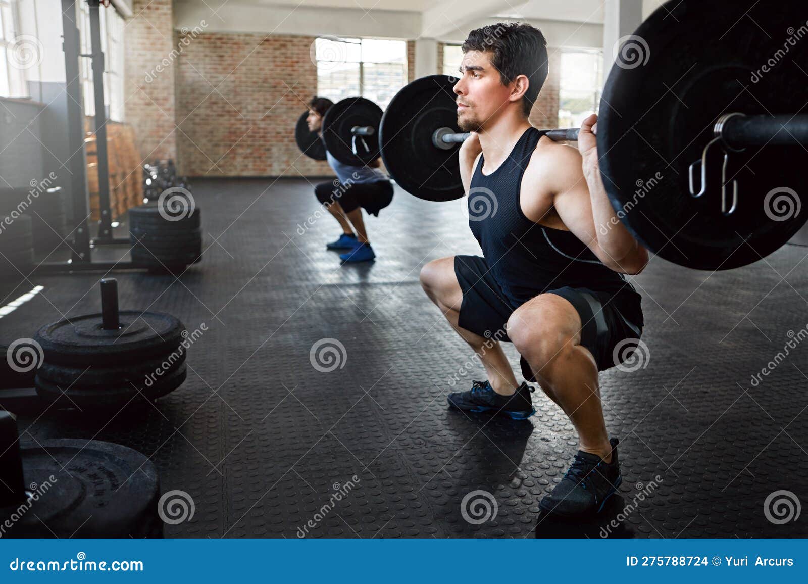 Squat and Lift. Young Men Working Out with Weights in the Gym. Stock ...
