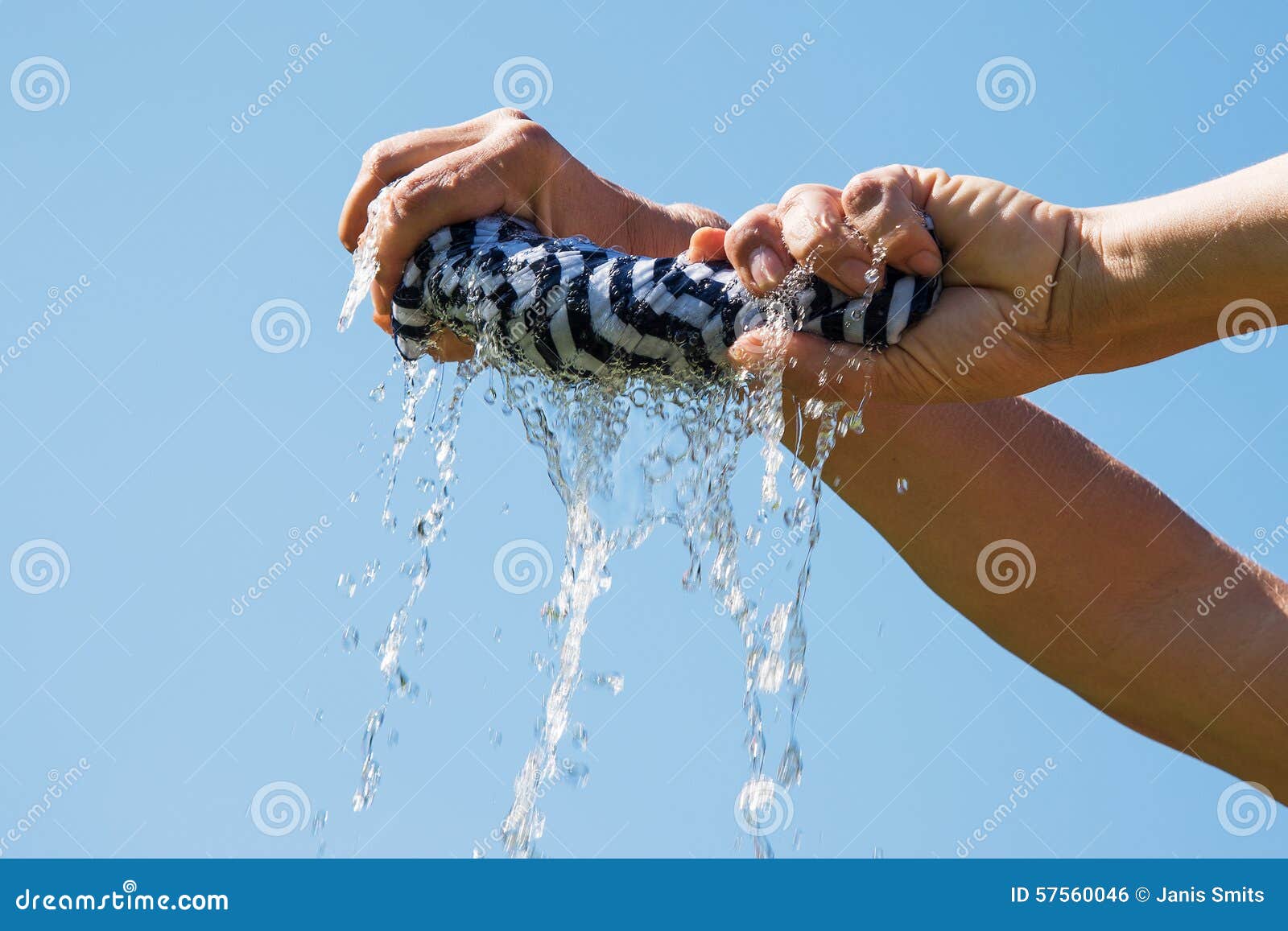 Squeezing of wet fabric. stock photo. Image of drying - 57560046