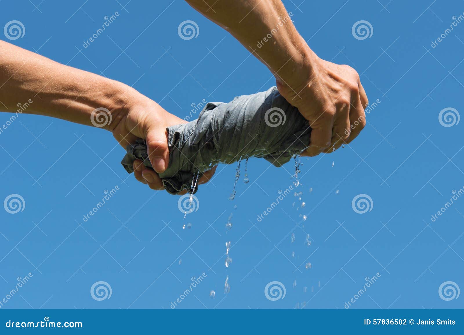 Squeezing of wet fabric. stock photo. Image of human - 57836502