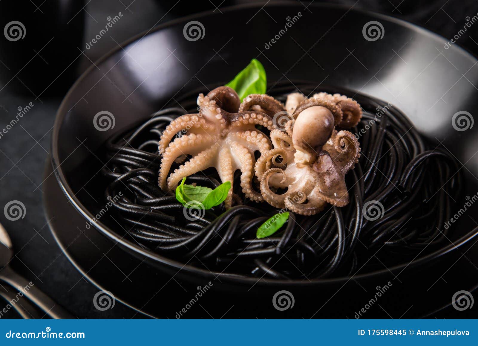 Black Squid Ink Spaghetti Pasta with Octopuses in Black Bowl Stock ...
