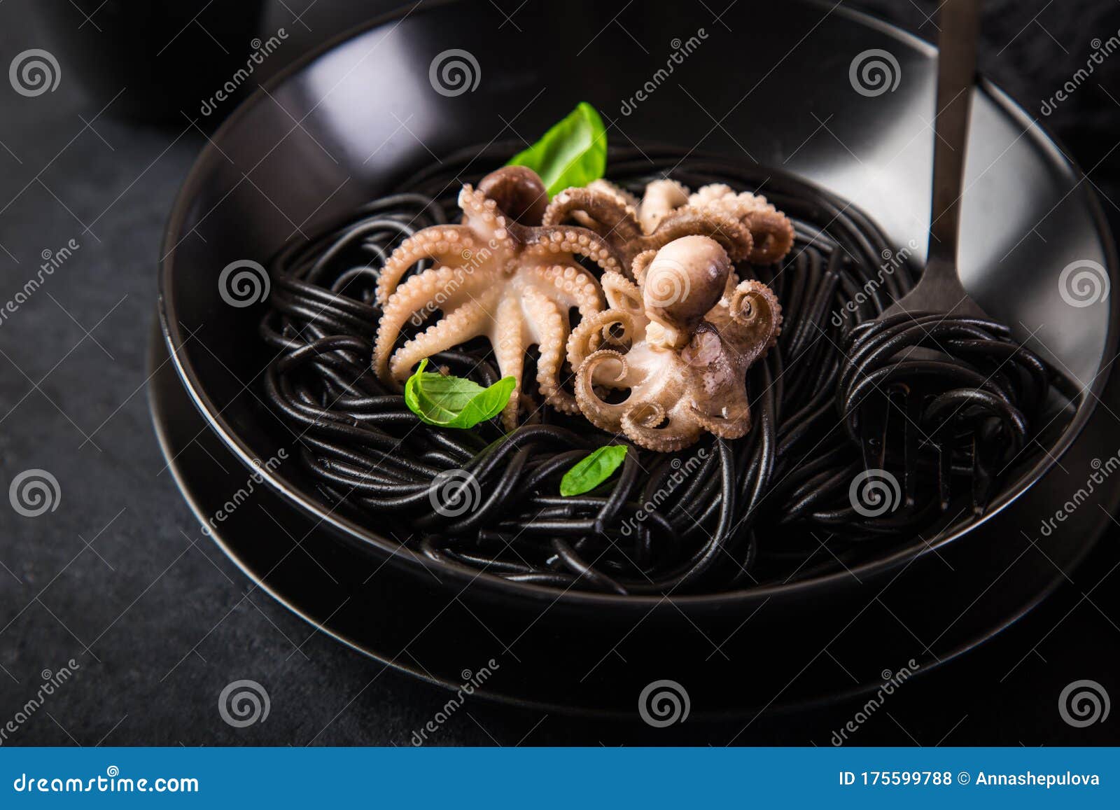 Squid Ink Spaghetti Pasta with Octopuses in Black Bowl Stock Photo ...