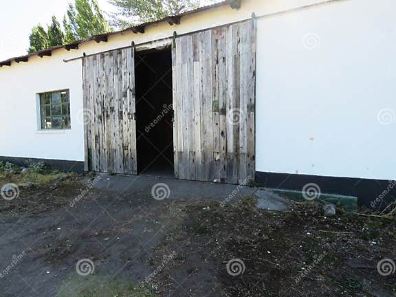 Stable in the Field. with Open Gate. Sun Rays Forming Iridescence Stock ...