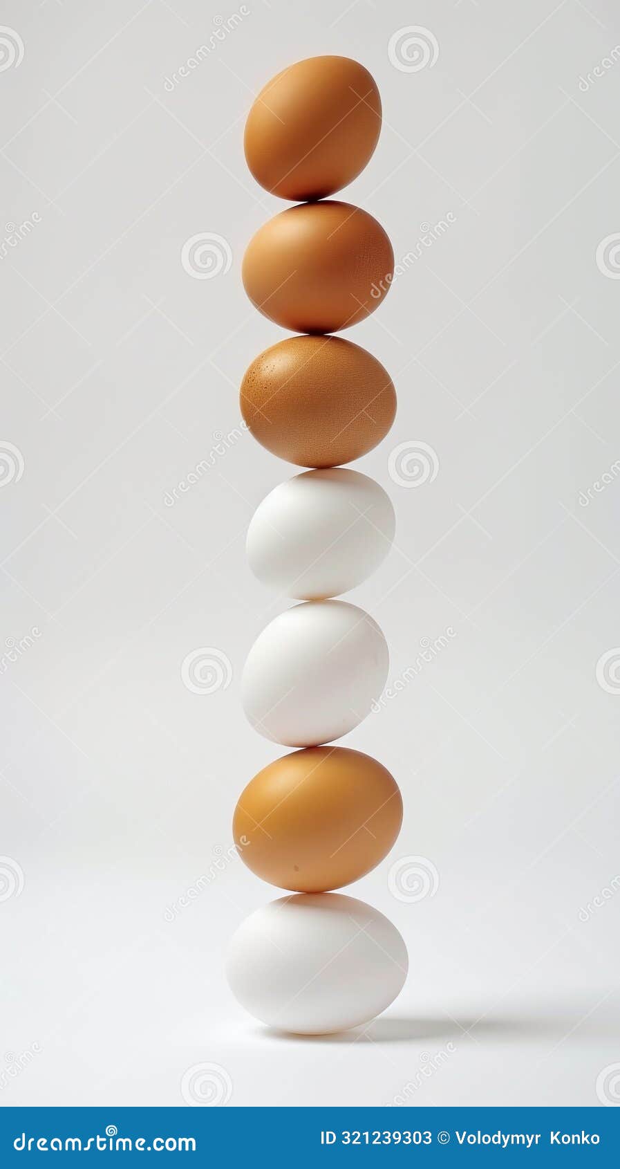 Stack of Alternating Brown and White Eggs on White Background. Balanced ...