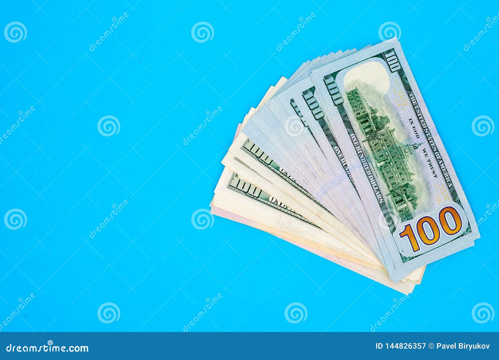 Stack of American Dollar Bills on Blue Background. Stock Image - Image ...