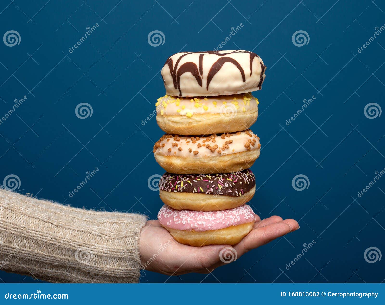 Stack of Assorted Delicious Colorful Donuts Near Dark Blue Background ...