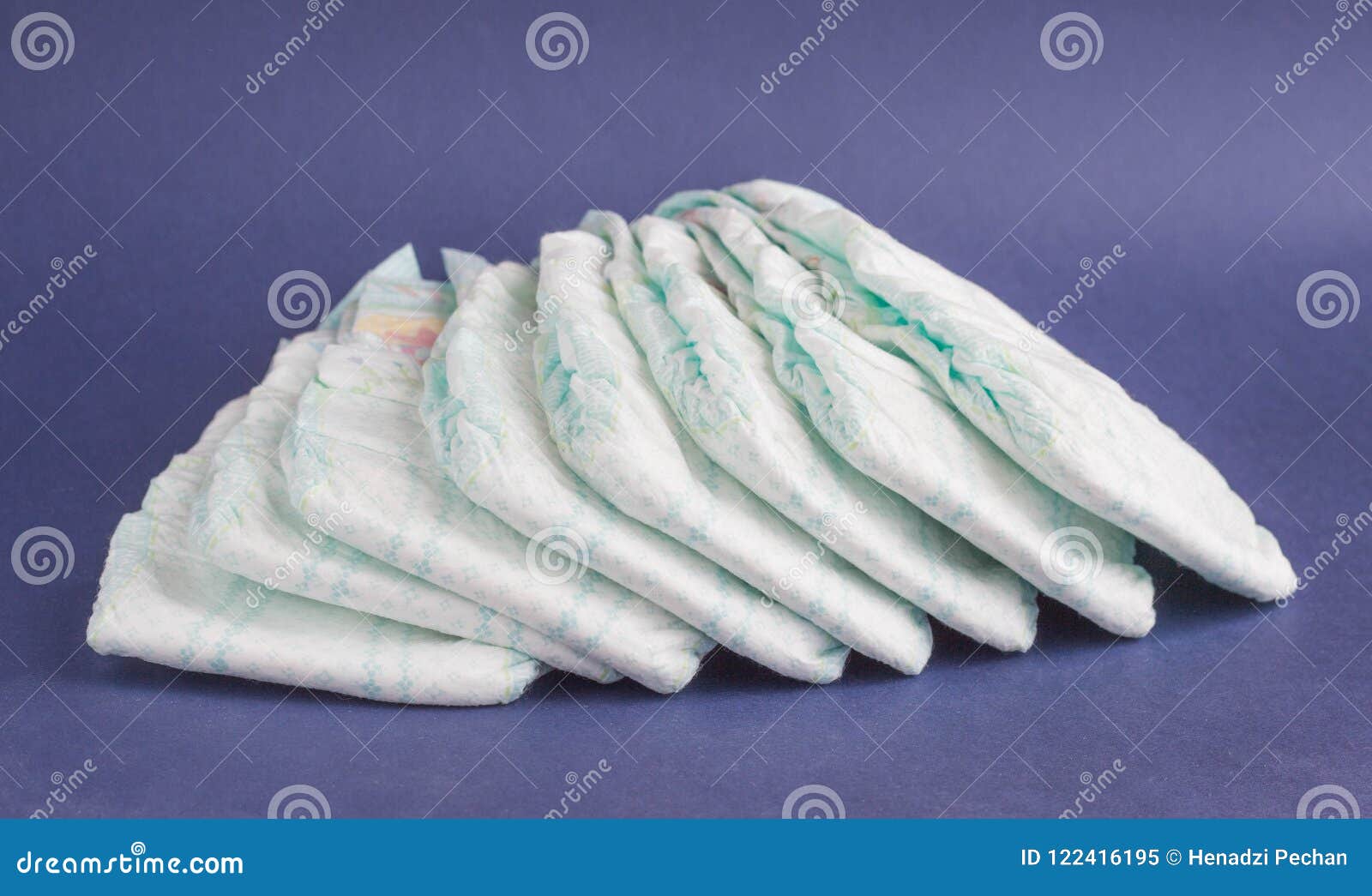 A Stack of Baby Diapers on a Blue Background Stock Image - Image of ...