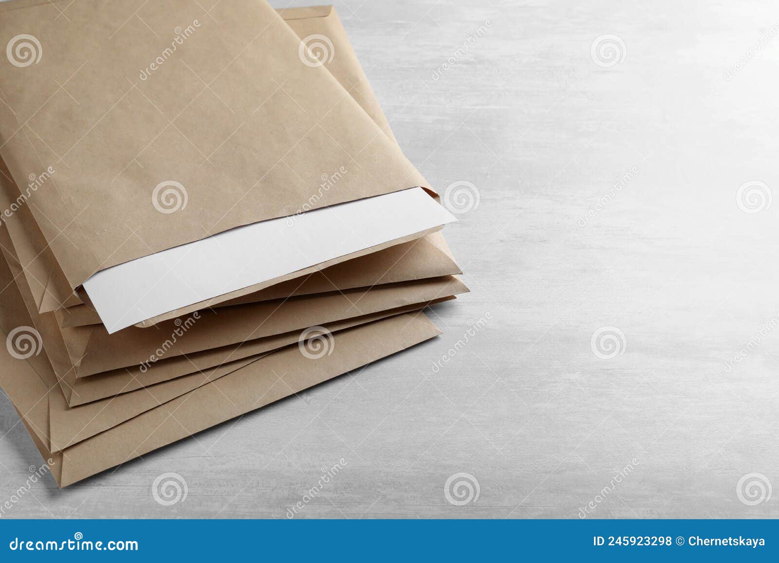Stack of Big Kraft Paper Envelopes on Light Table, Closeup Stock Photo ...