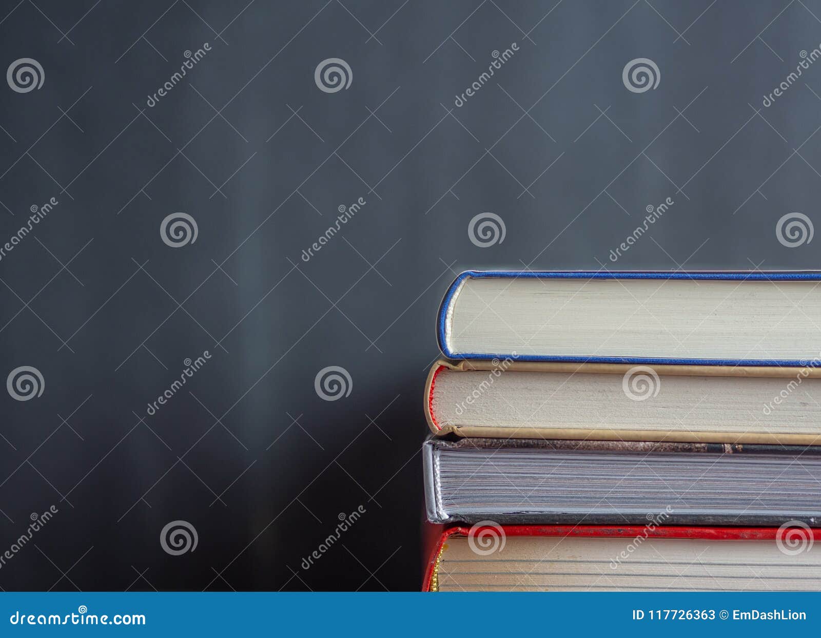 Stack of Book Resting in Front of a Chalkboard Stock Image - Image of ...