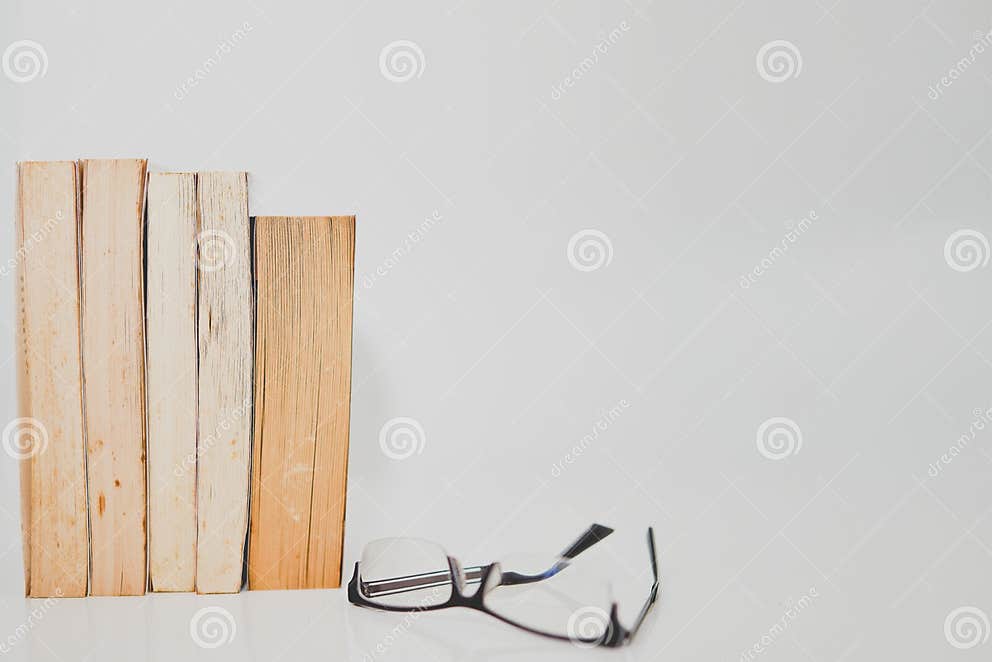 Stack of Books Arranged Horizontally on White Background with Glasses ...