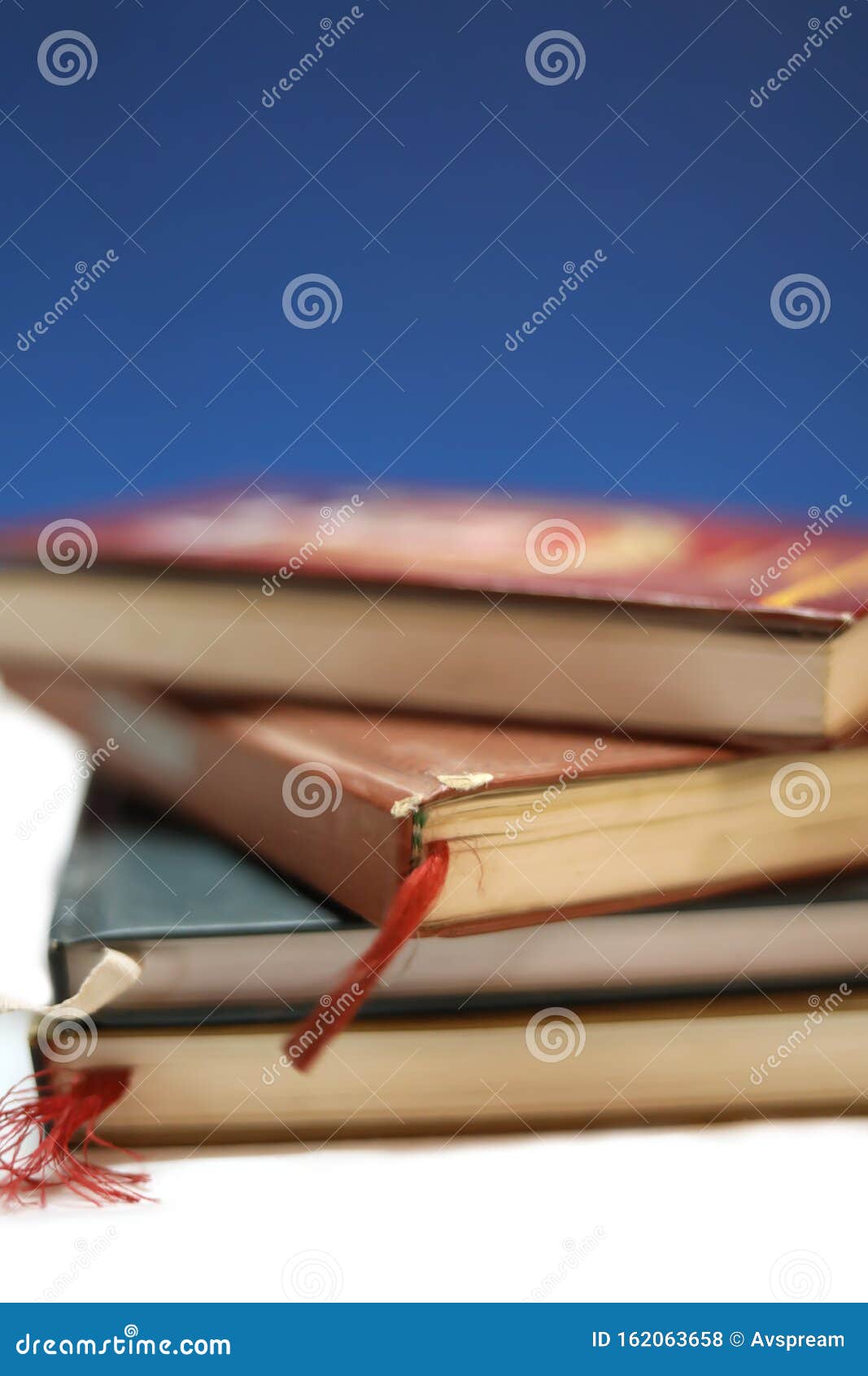 A Stack of Books on Blue Background Stock Photo - Image of concept ...