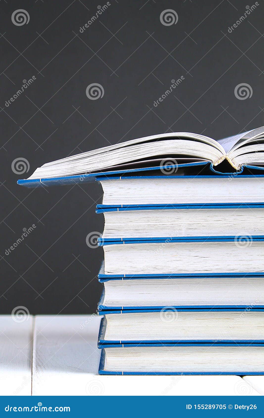 A Stack Of Books On Chalkboard Background One Hidden Book On Top Of