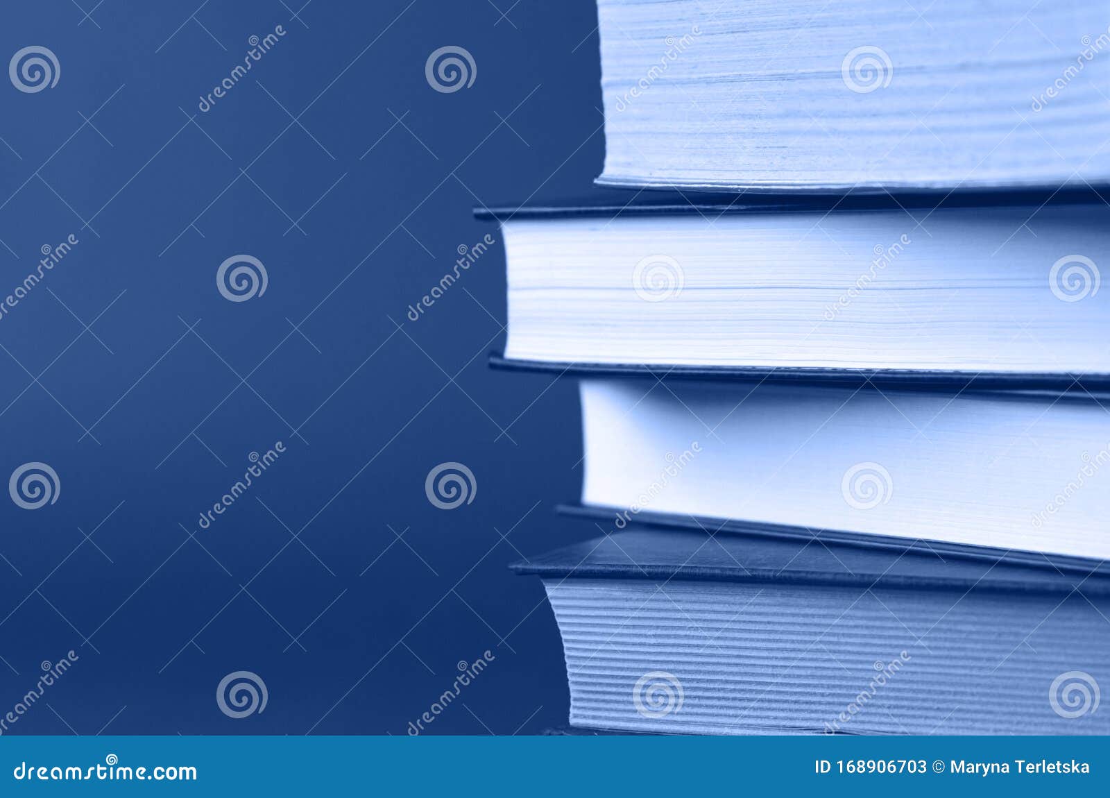 A Stack of Books on a Classic Blue Background Stock Image - Image of ...