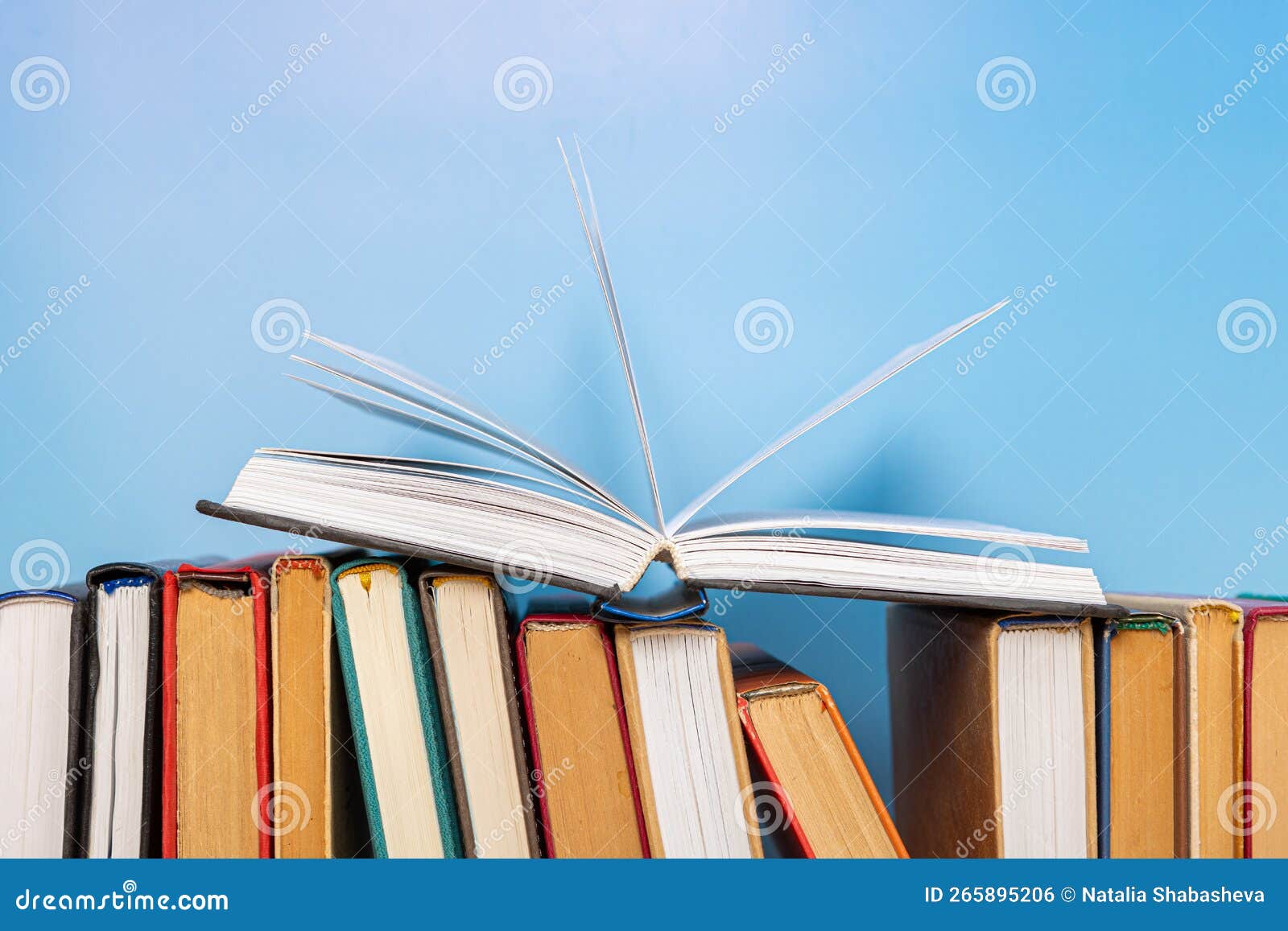 Stack of Books in the Colored Cover Lay on Blue Backround. Education ...