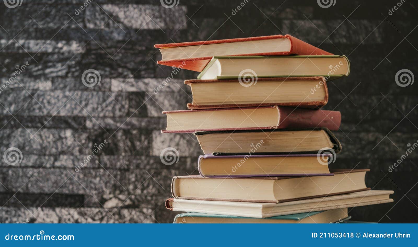 Stack of Books in the Colored Cover Lay on the Wood Table with Brick ...