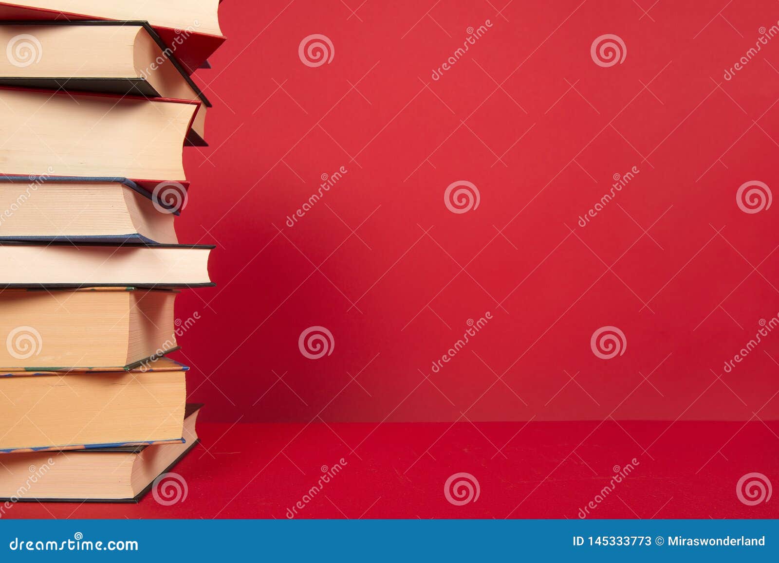 Stack of Books in the Corner on a Red Background Stock Image - Image of ...