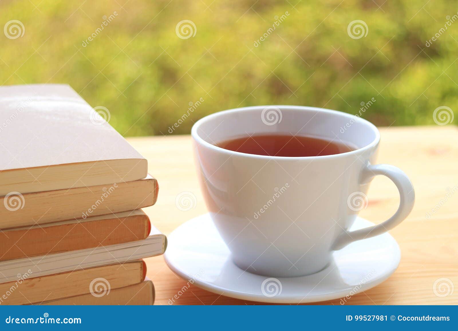 Stack of Books and a Cup of Hot Tea on a Table by the Window Stock ...