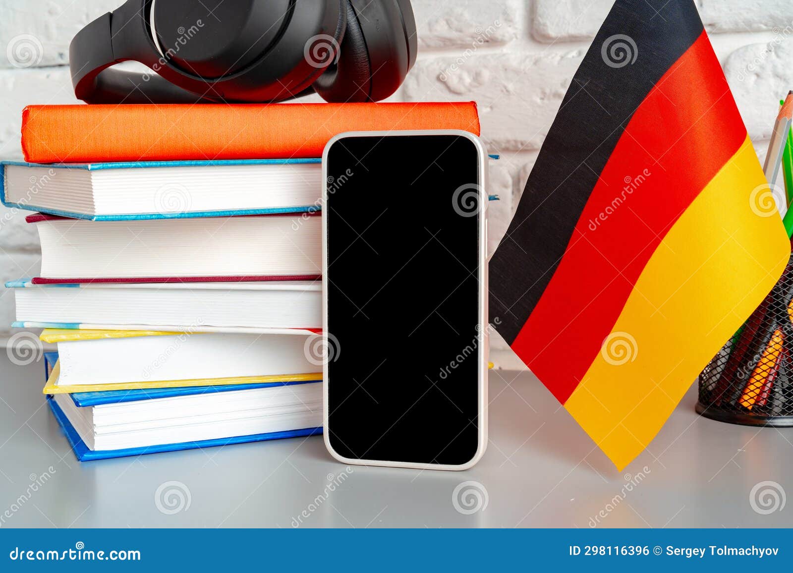 Stack of Books and Flag of Germany on Desk. German Language Learning ...