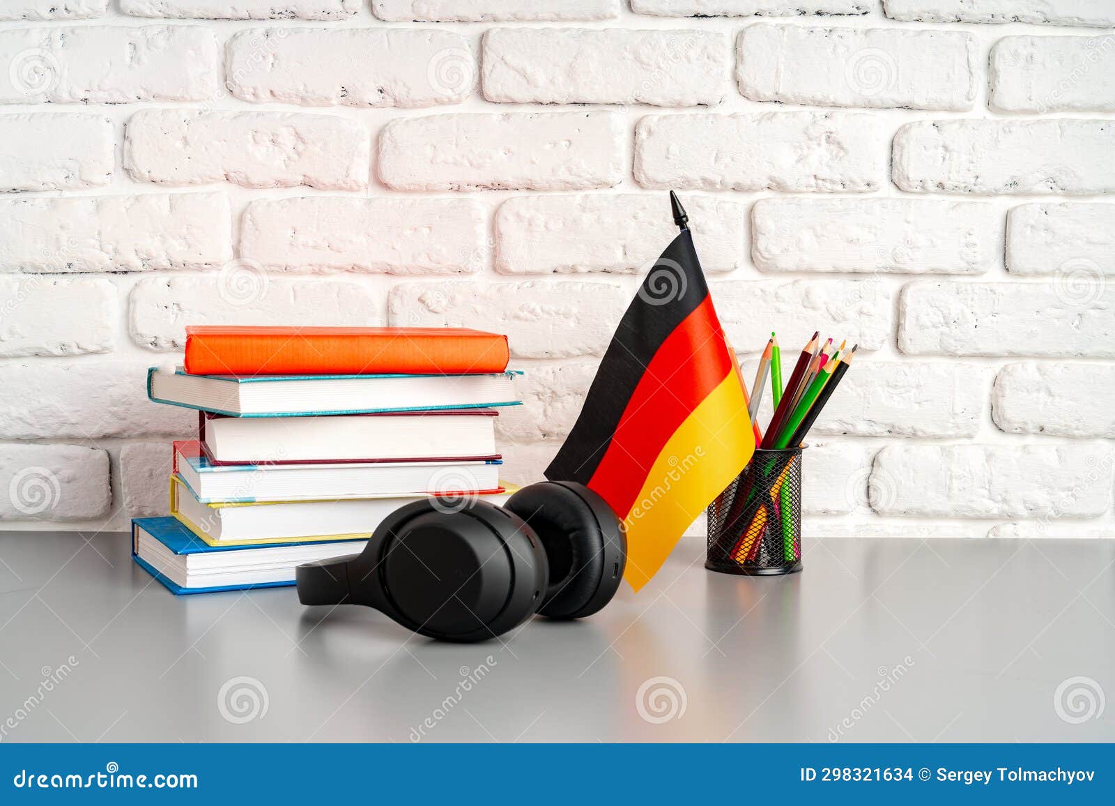 Stack of Books and Flag of Germany on Desk. German Language Learning ...