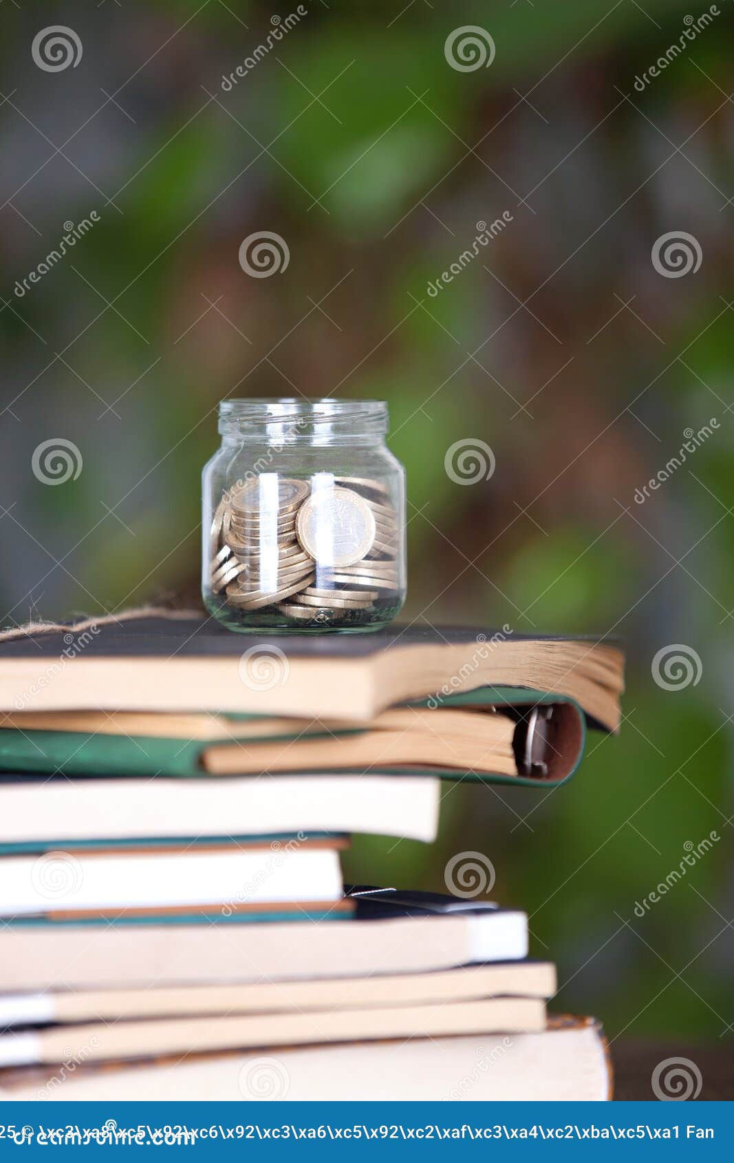 A Stack of Books and a Glass of Coins Stock Image - Image of objects ...
