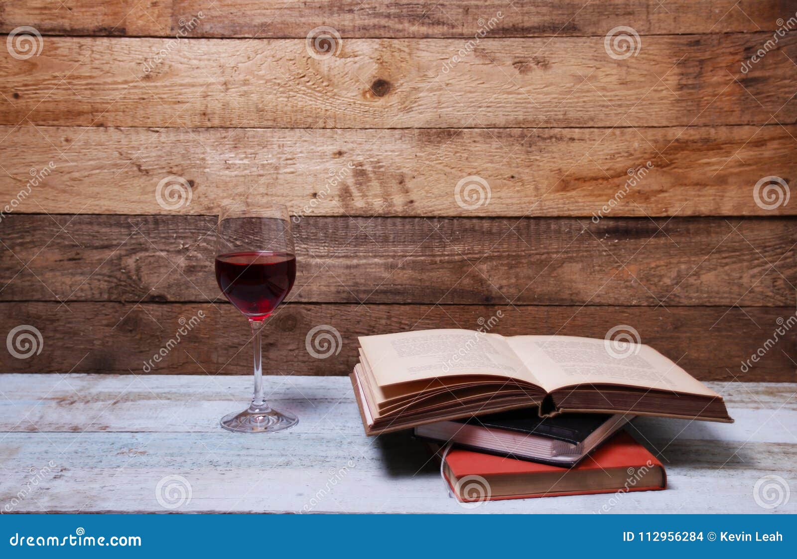 A Stack of Books and a Glass of Red Wine Stock Photo - Image of book ...