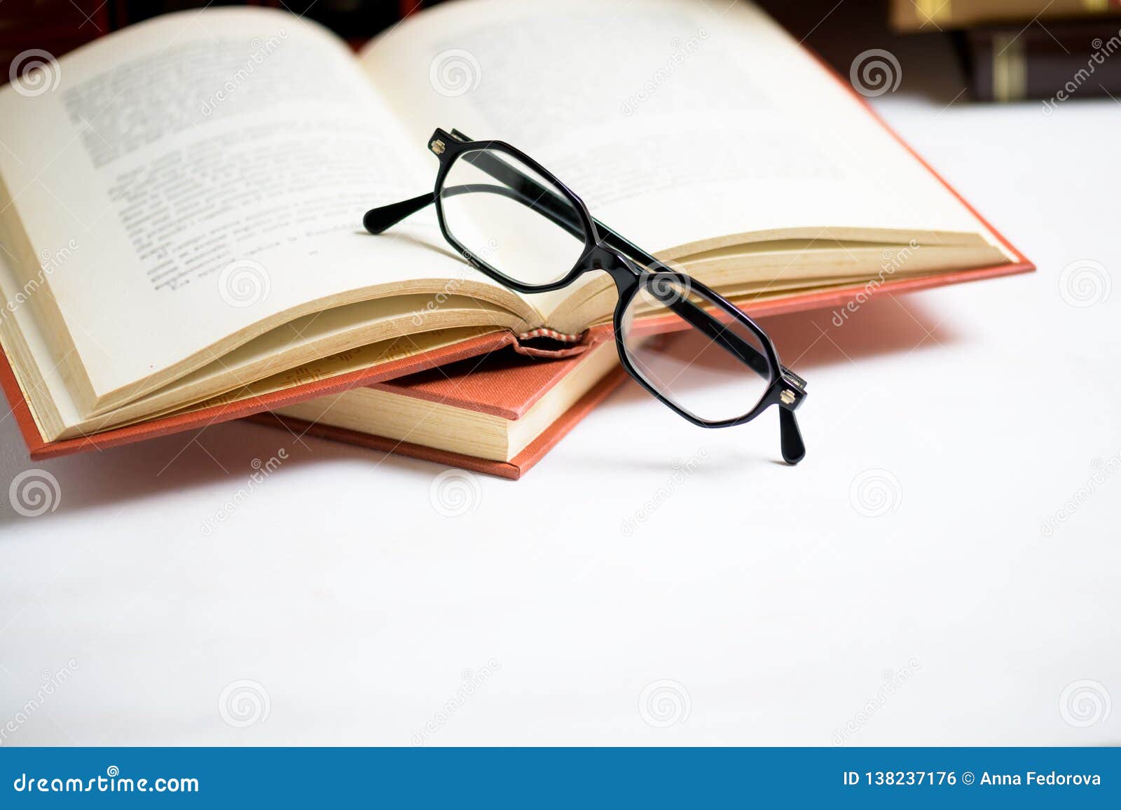 Stack of Books with Glasses Placed on the Open Book in Library Stock ...