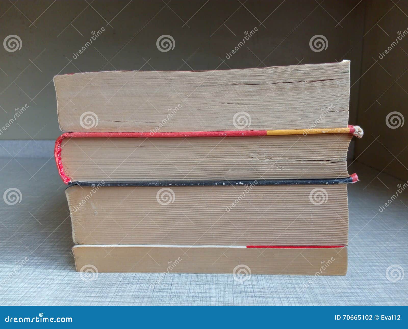 A Stack of Books on a Gray Table Side View of the Bottom of the Books ...