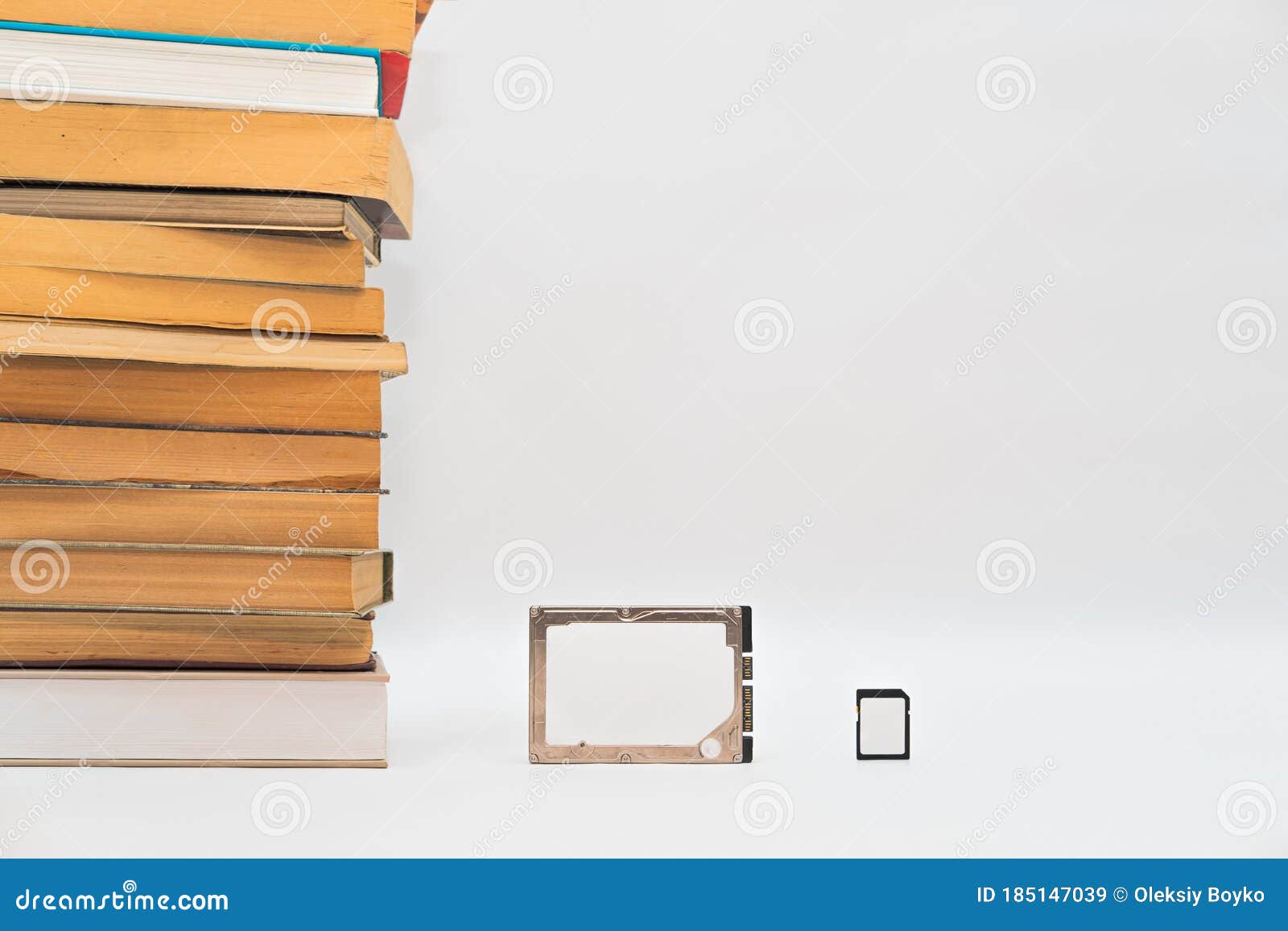 Stack of Books, Hard Disk Drive and Memory Card, Improving Technology ...