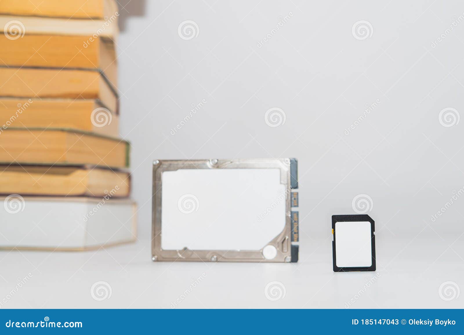 Stack of Books, Hard Disk Drive and Memory Card, Improving Technology ...