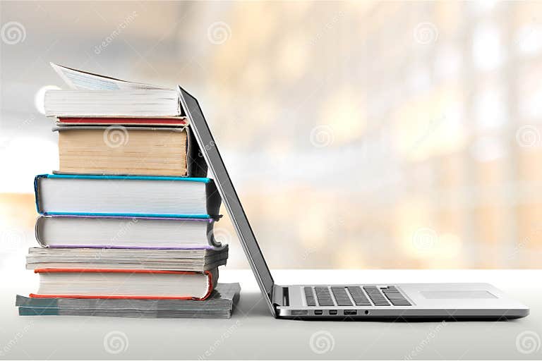Stack of books with laptop stock photo. Image of office - 112218380