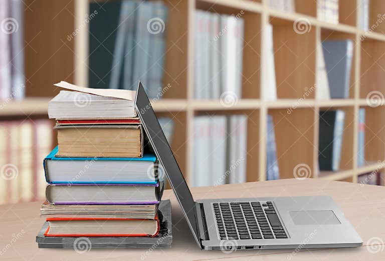 Stack of Books with Laptop on Wooden Table Stock Photo - Image of pile ...