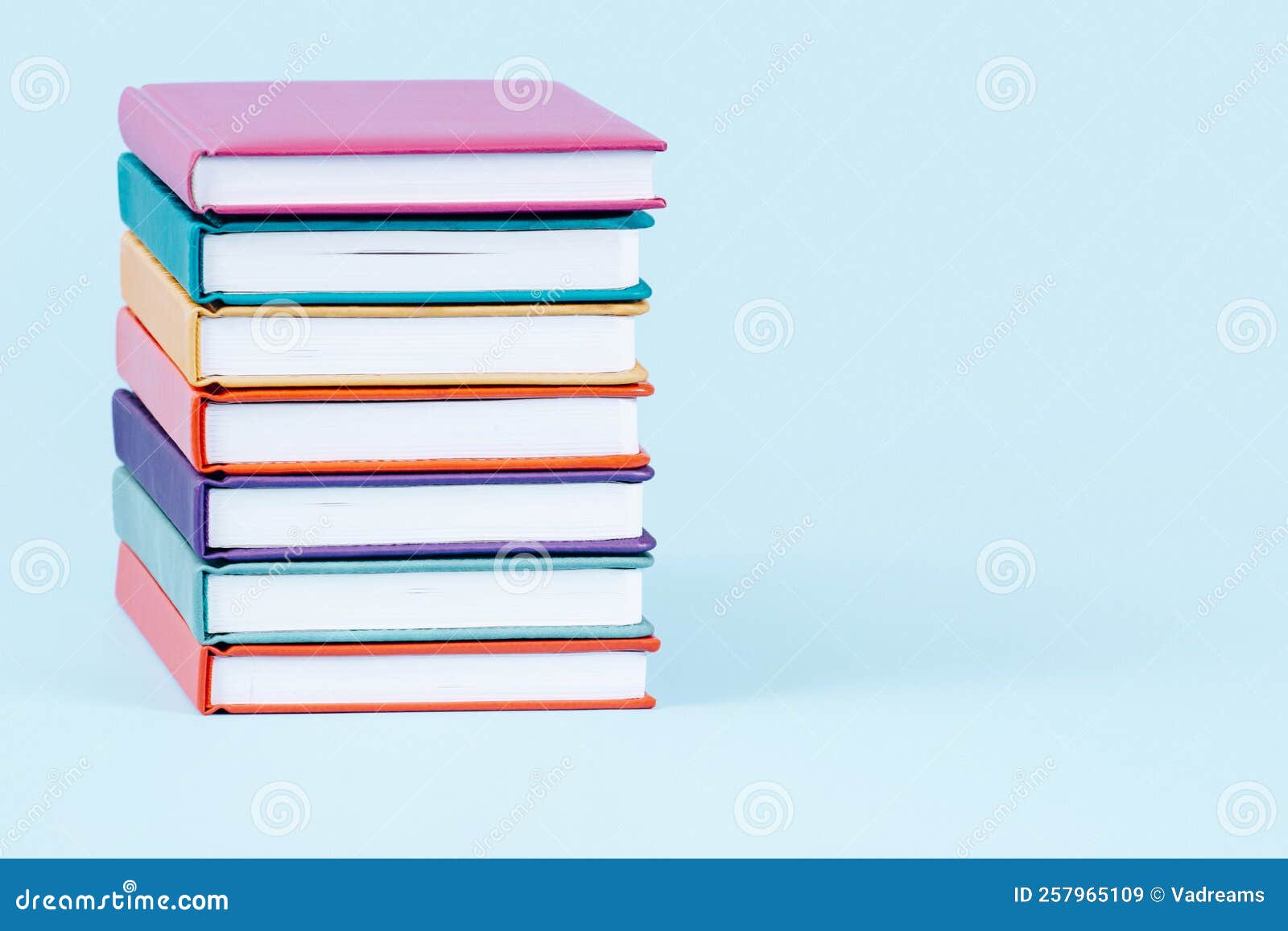 Stack of Books on Light Blue Background. Front View, Copy Space Fot ...