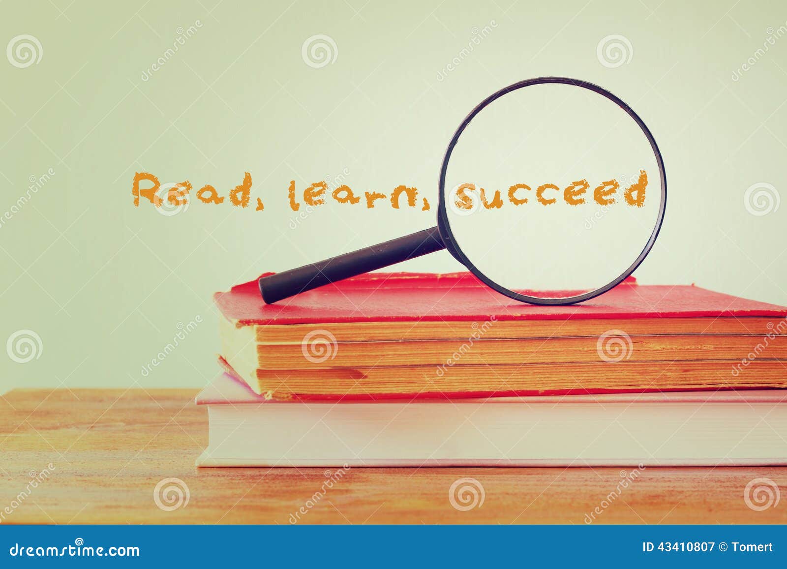 Stack of Books and Magnifying Glass with the Phrase Learn Read Succeed ...