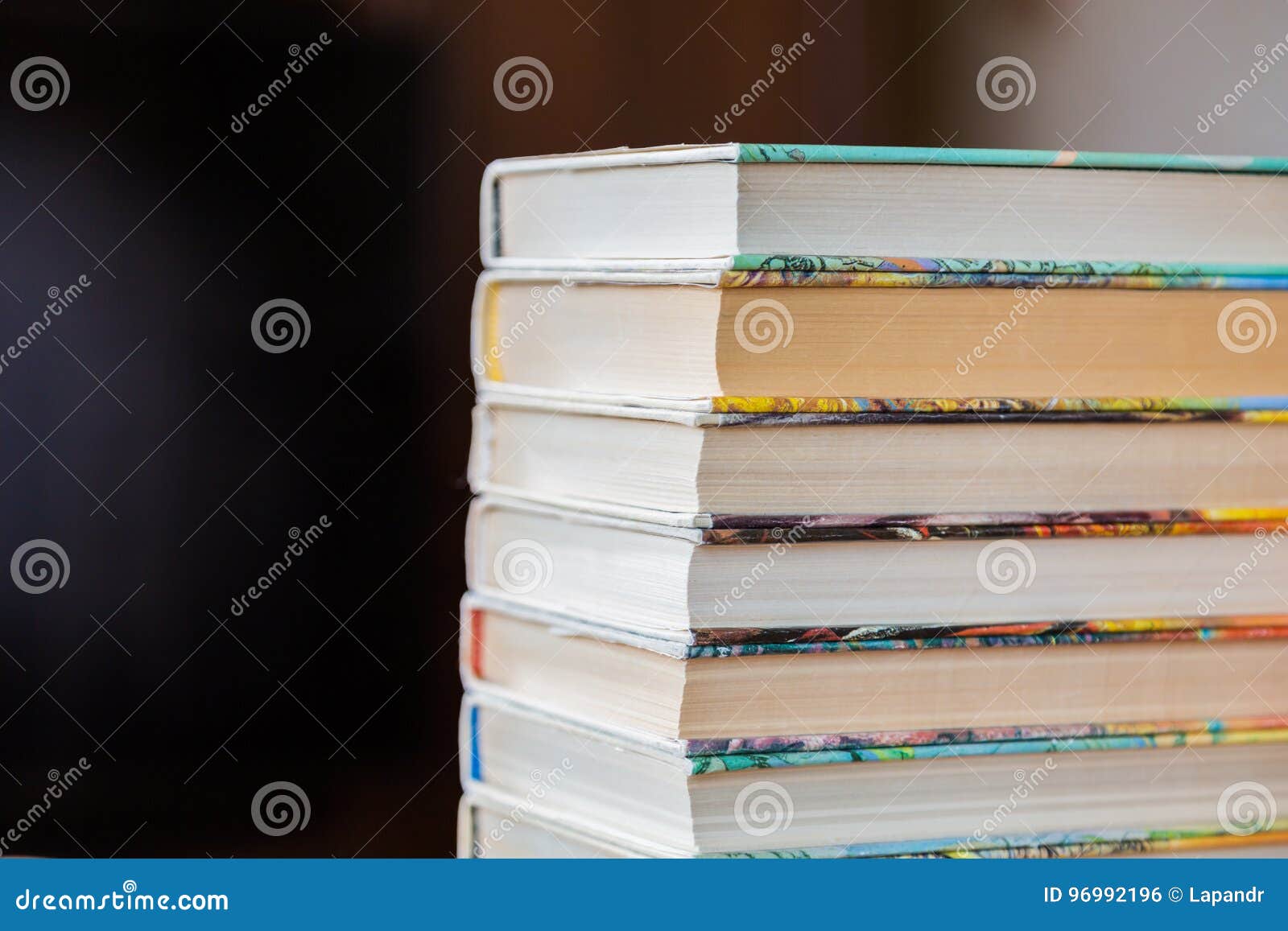A Stack of Books in Multicolored Covers in the Library or Bookstore ...