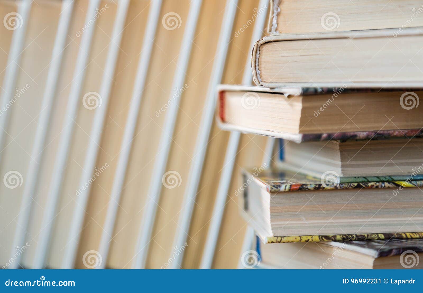 A Stack of Books in Multicolored Covers in the Library or Bookstore ...