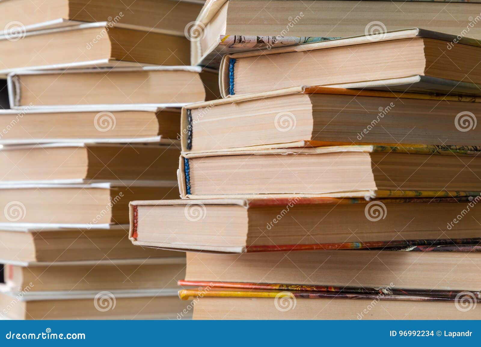 A Stack of Books in Multicolored Covers in the Library or Bookstore ...