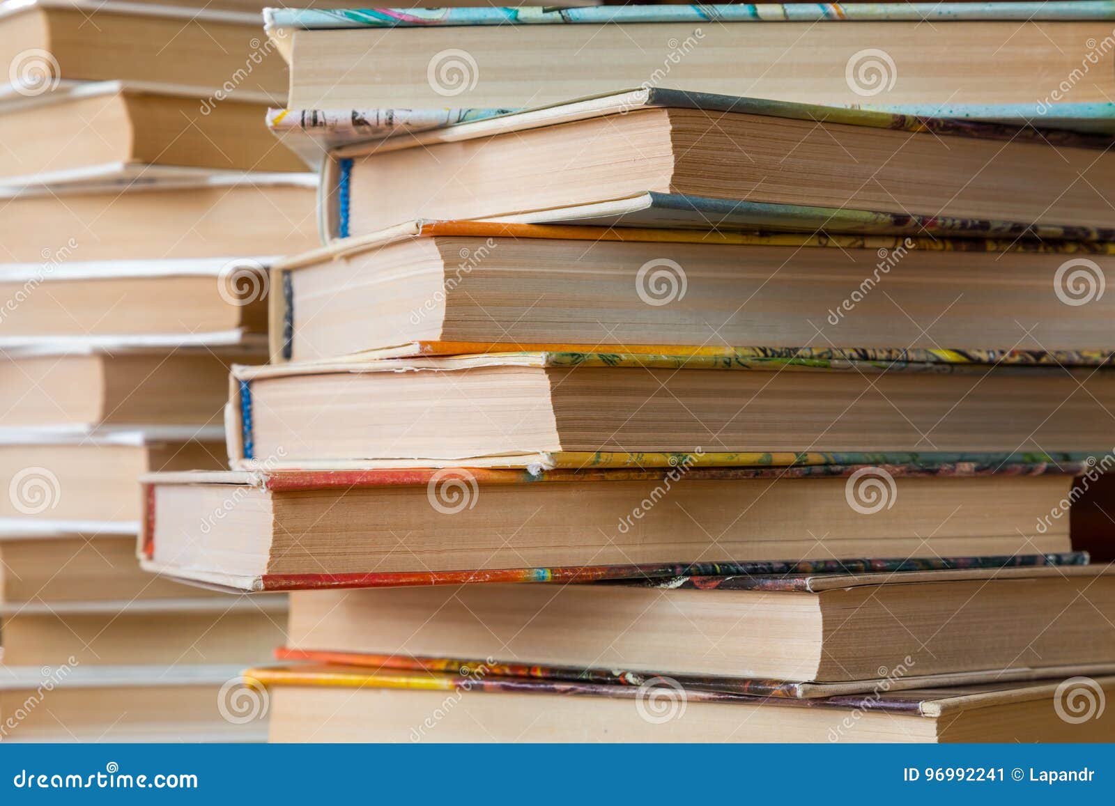 A Stack of Books in Multicolored Covers in the Library or Bookstore ...