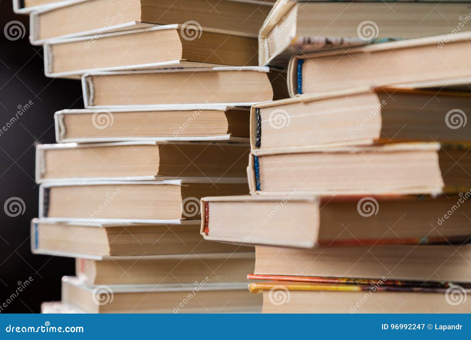 A Stack of Books in Multicolored Covers in the Library or Bookstore ...