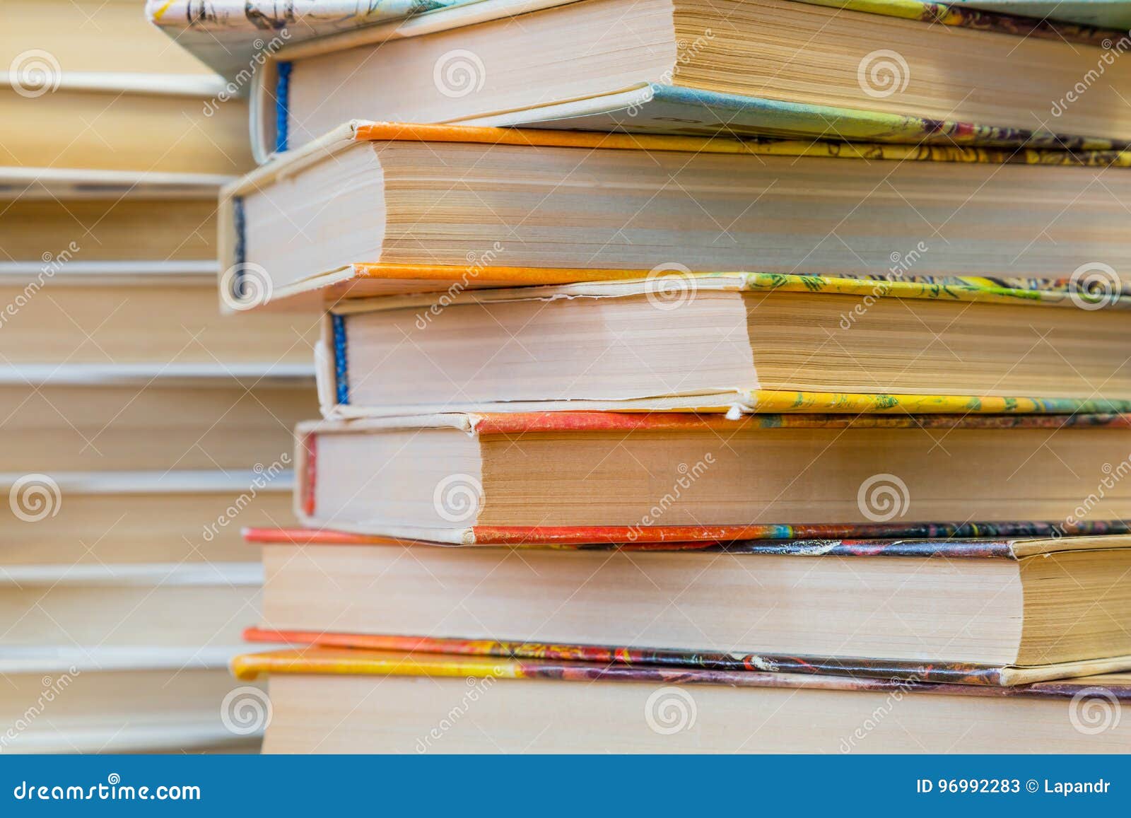 A Stack of Books in Multicolored Covers in the Library or Bookstore ...