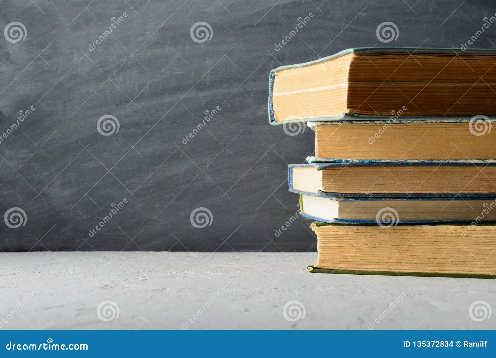 Stack of Books Near Empty Chalkboard Stock Photo - Image of literature ...