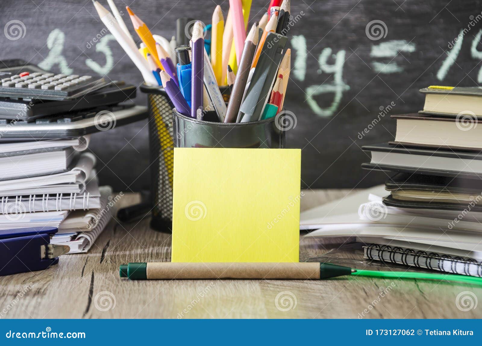 Stack of Books, Notebooks, Pens, Calculator and Writing Tools Against a ...