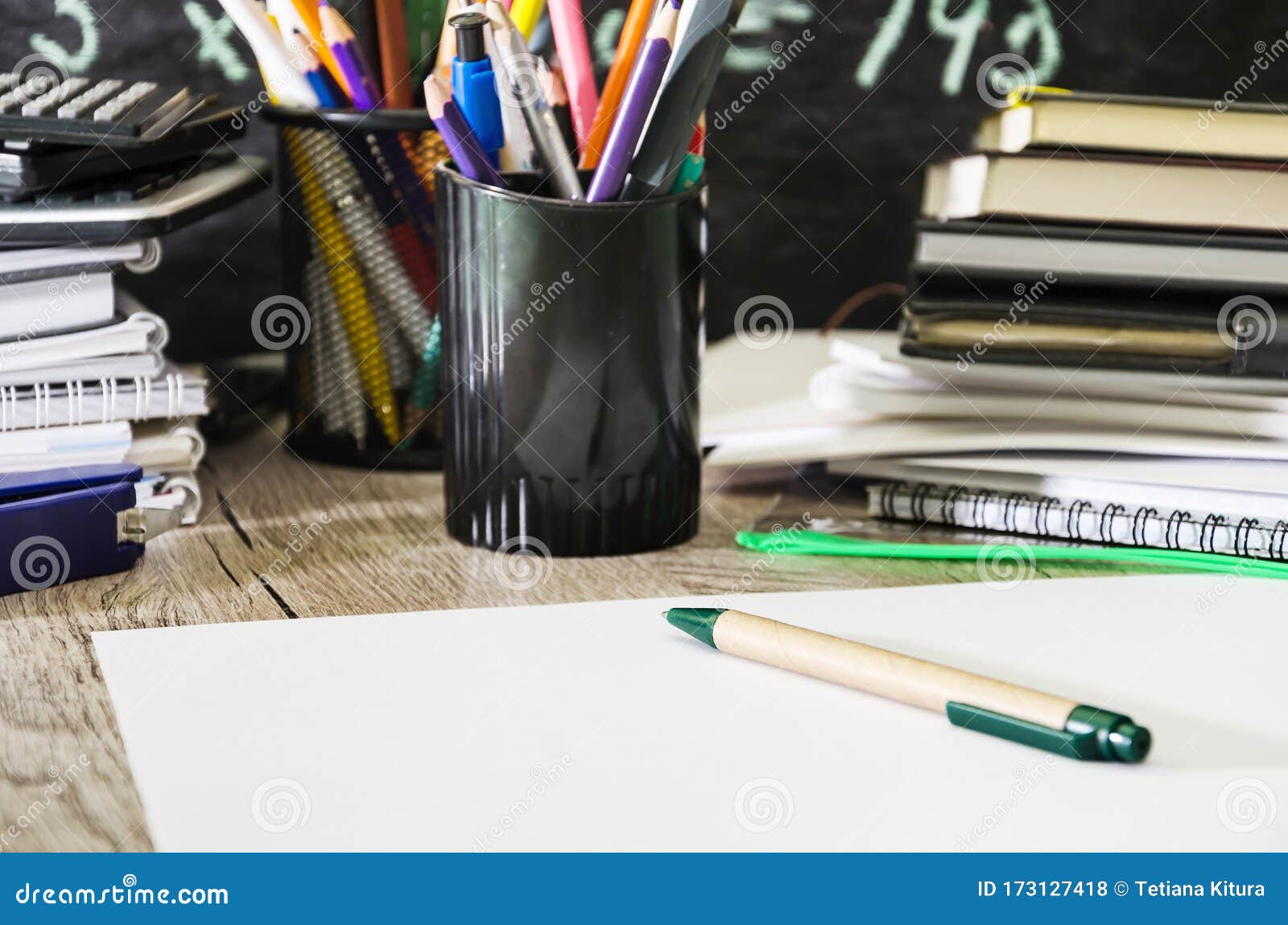 Stack of Books, Notebooks, Pens, Calculator and Writing Tools Against a ...