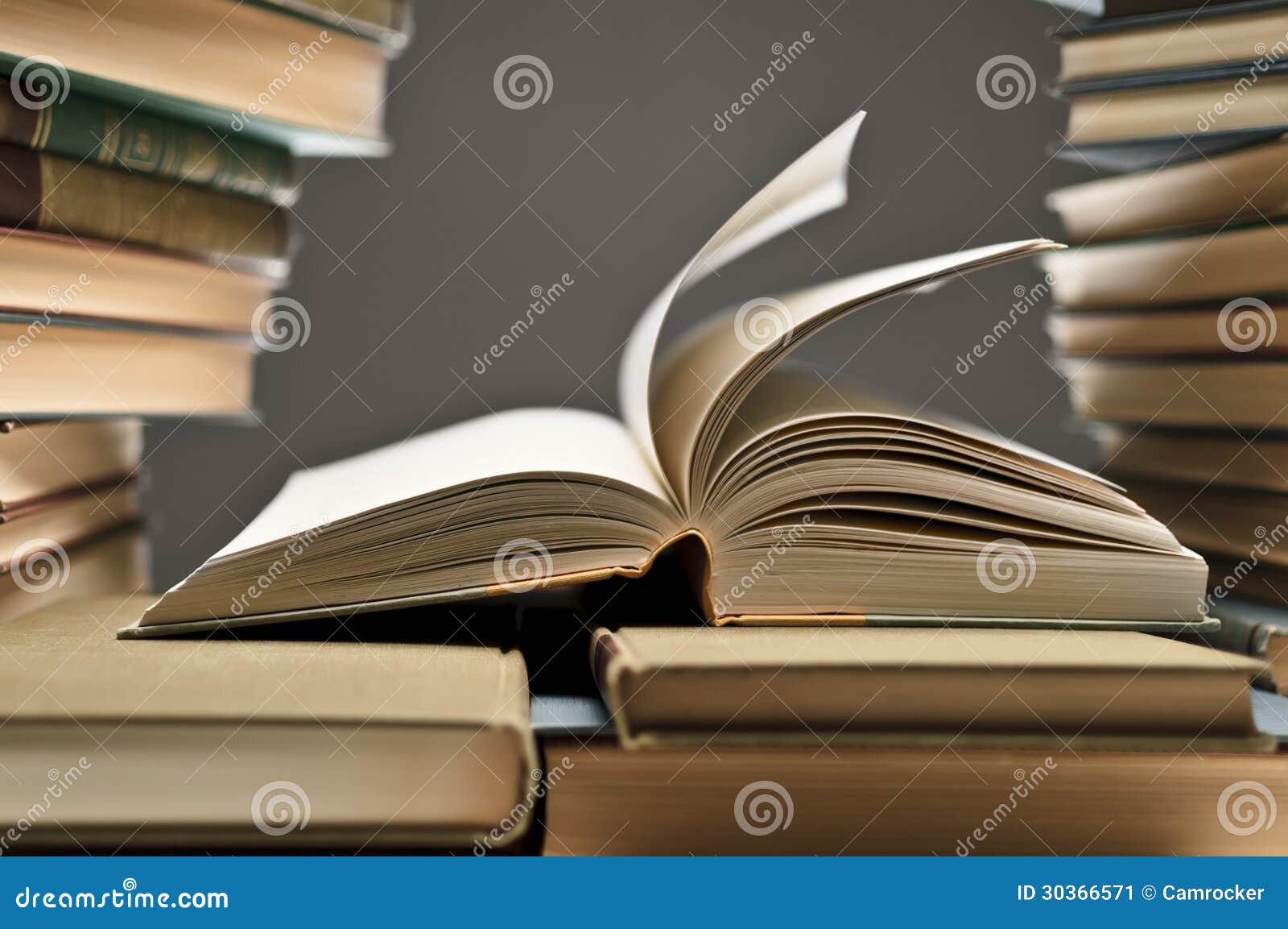 Stack of Books with One Open among Them Stock Image - Image of backlit ...