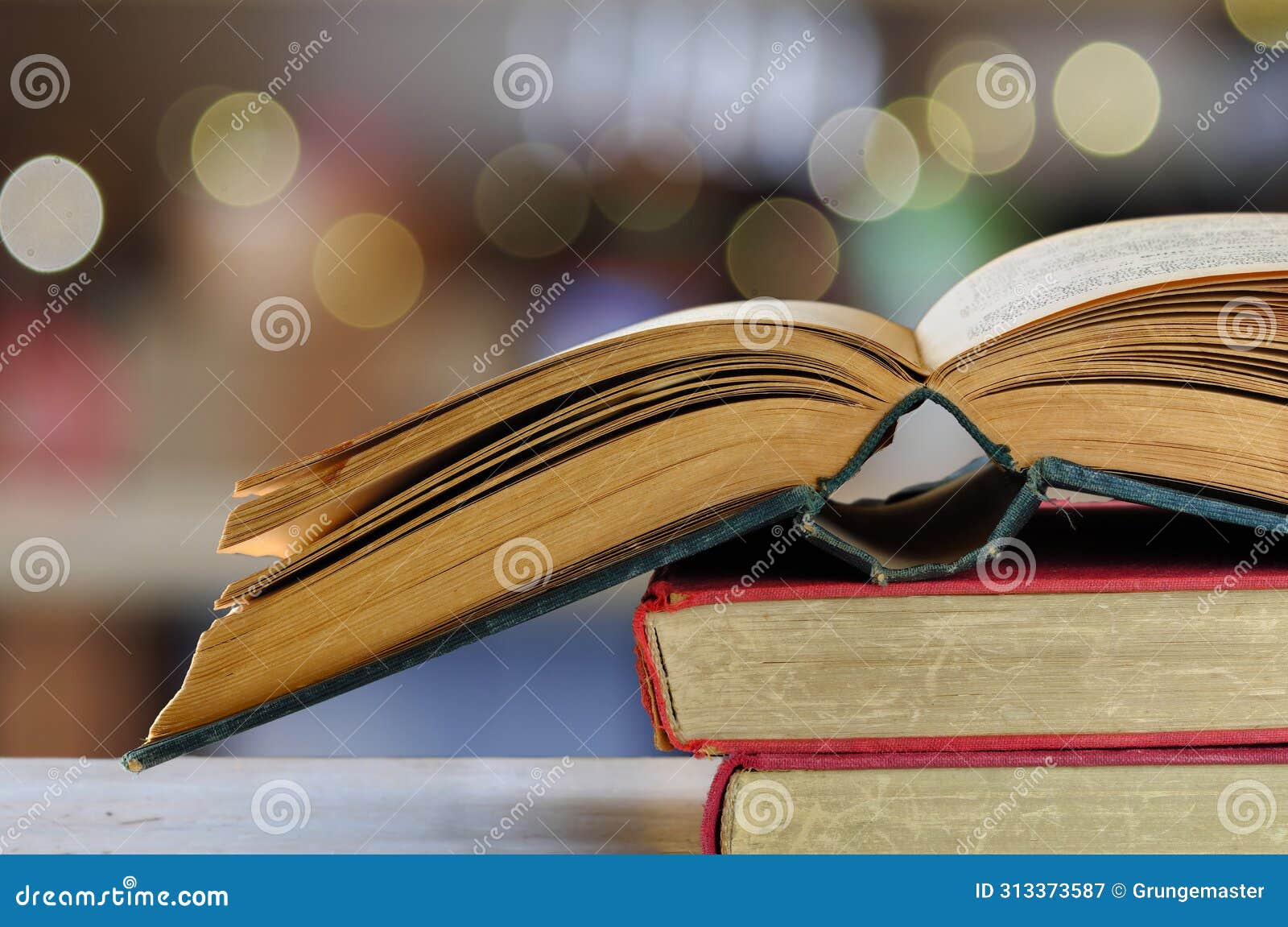 Stack of Books and Open Book with Blurred Bookshelf Background, Reading ...