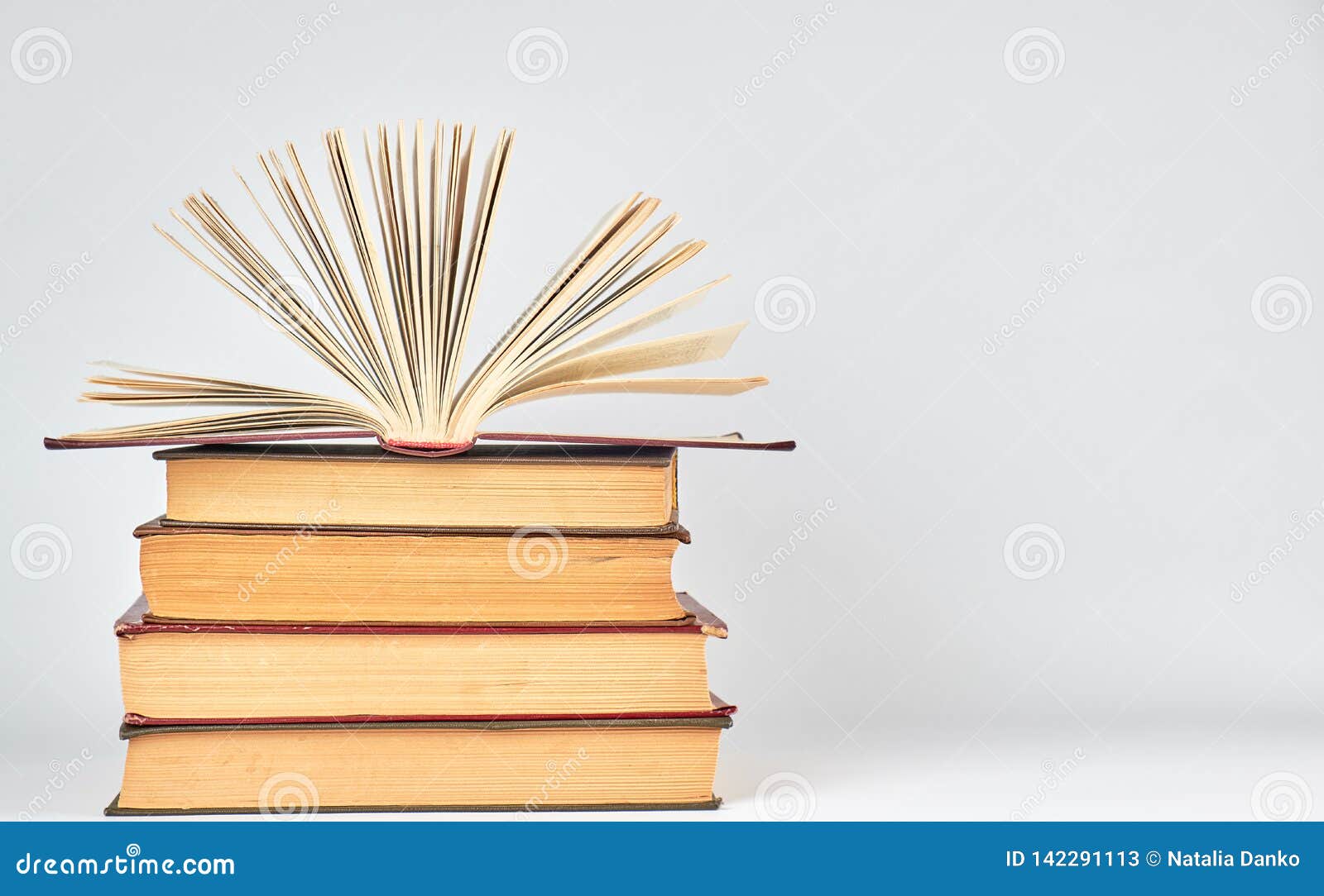 Stack of Books and an Open Book with Yellow Pages Stock Image - Image ...