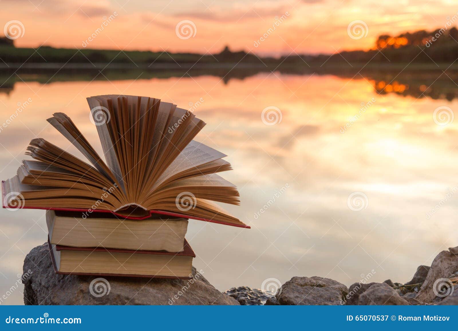 Stack of Books and Open Hardback Book on Blurred Stock Image - Image of ...