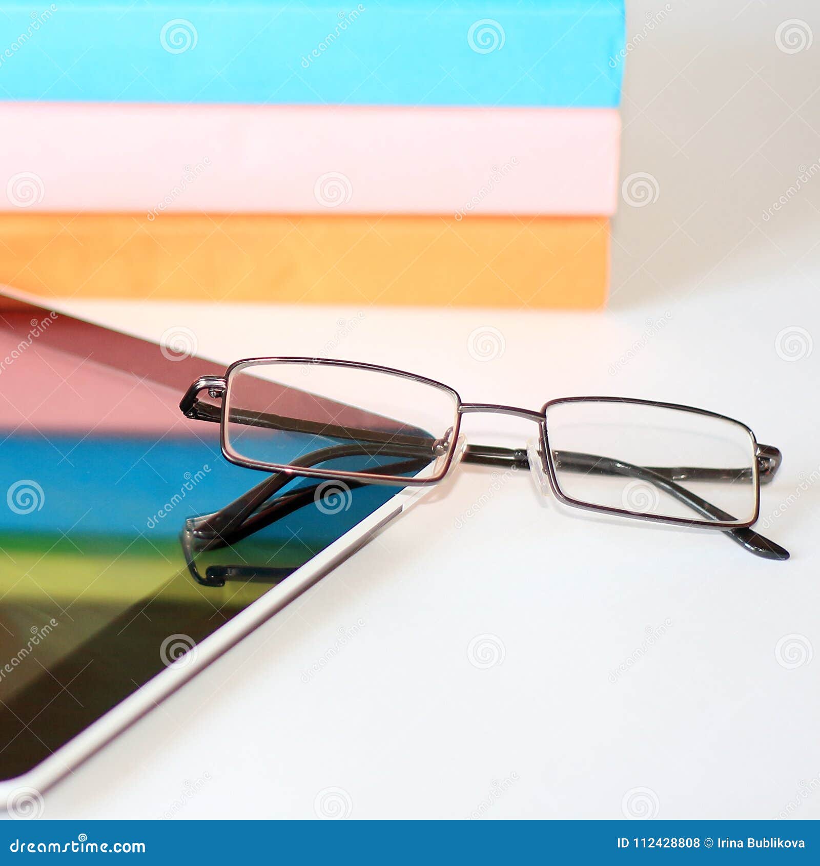 Stack of Books with a Pair of Eyeglasses Stock Photo - Image of ...