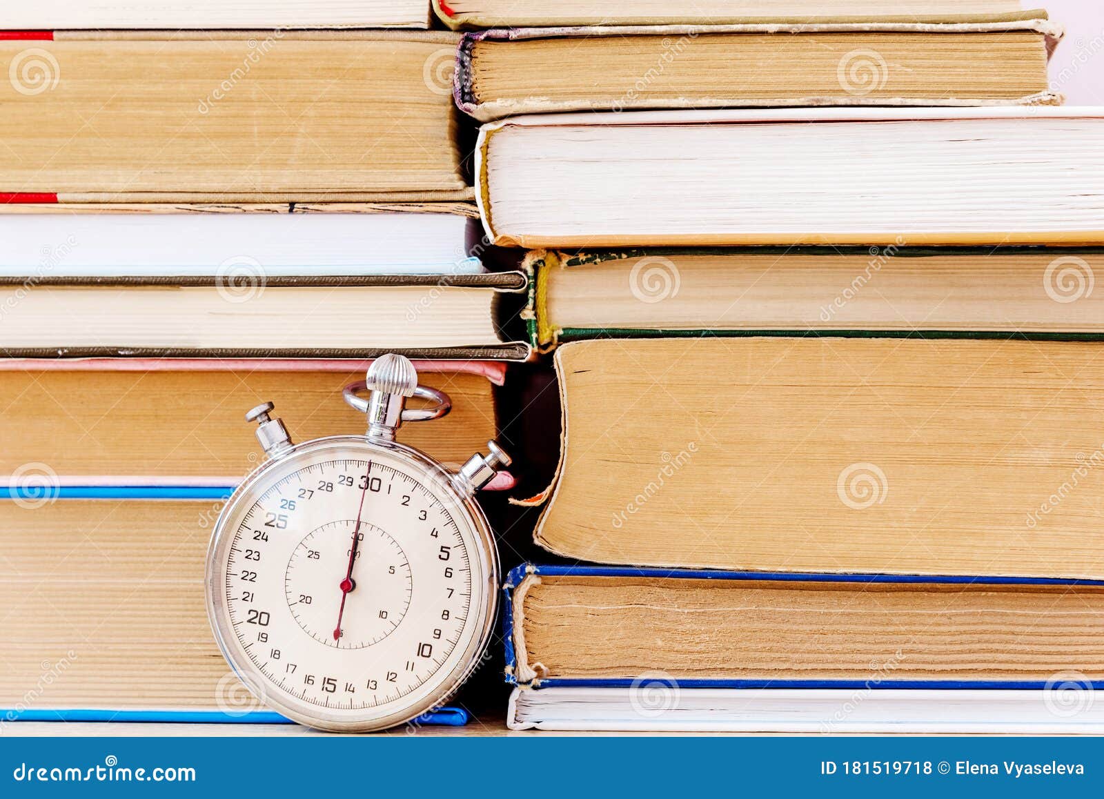 Stack of Books and Stopwatch on Simple Backdrop. Copy Space for Your ...