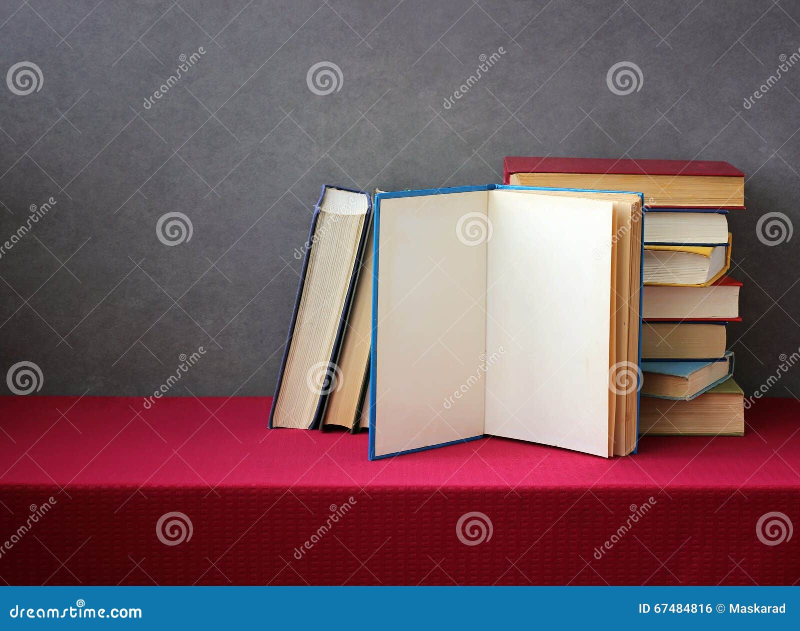 A Stack of Books on the Table with a Red Tablecloth. Stock Photo ...