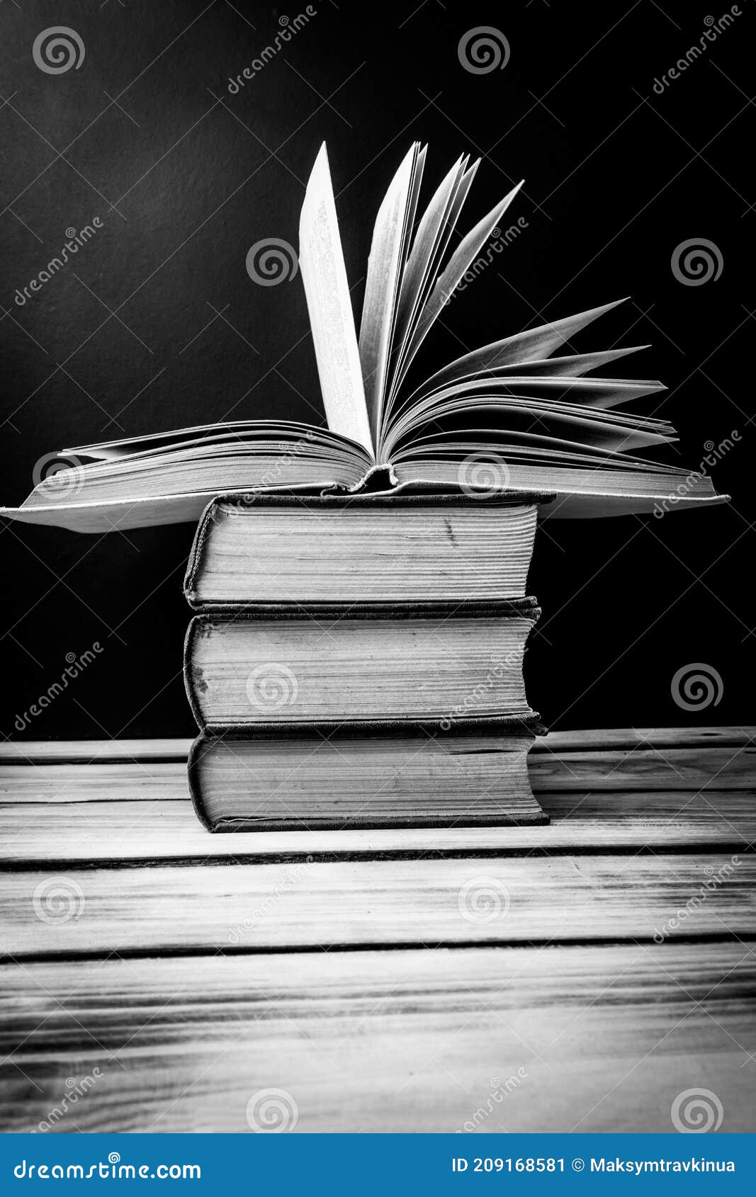 A Stack of Books on the Table. at the Top is an Open Book Stock Image ...